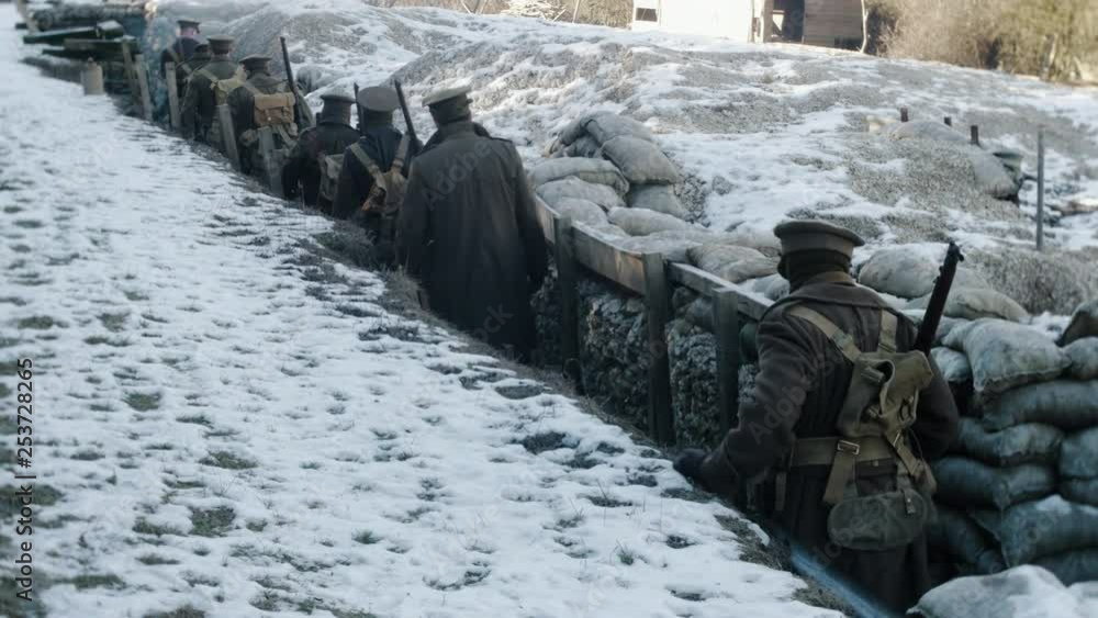 World War One British soldiers walk through a trench towards the front ...