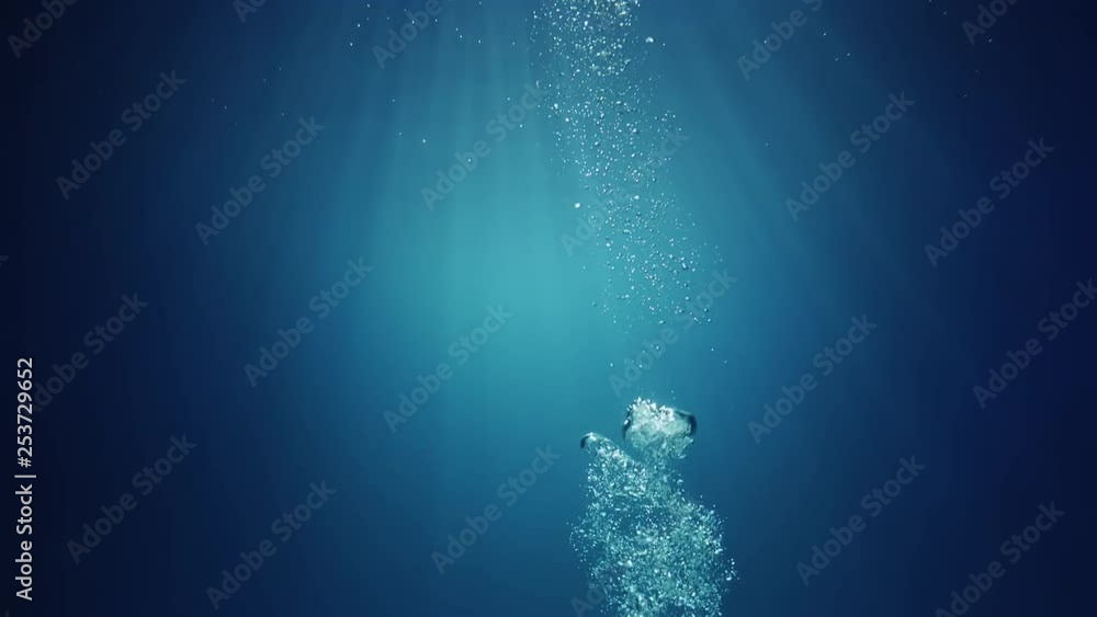 Underwater sunlight beams shining from above coming through the deep ...