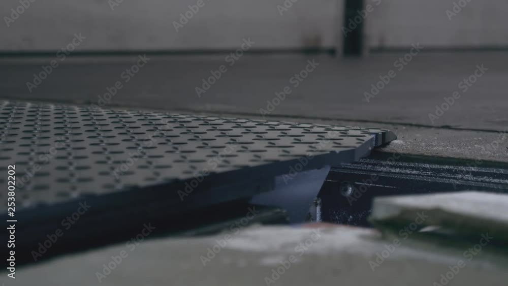 Close-up Automatic loading platform lowered in the logistics center ...