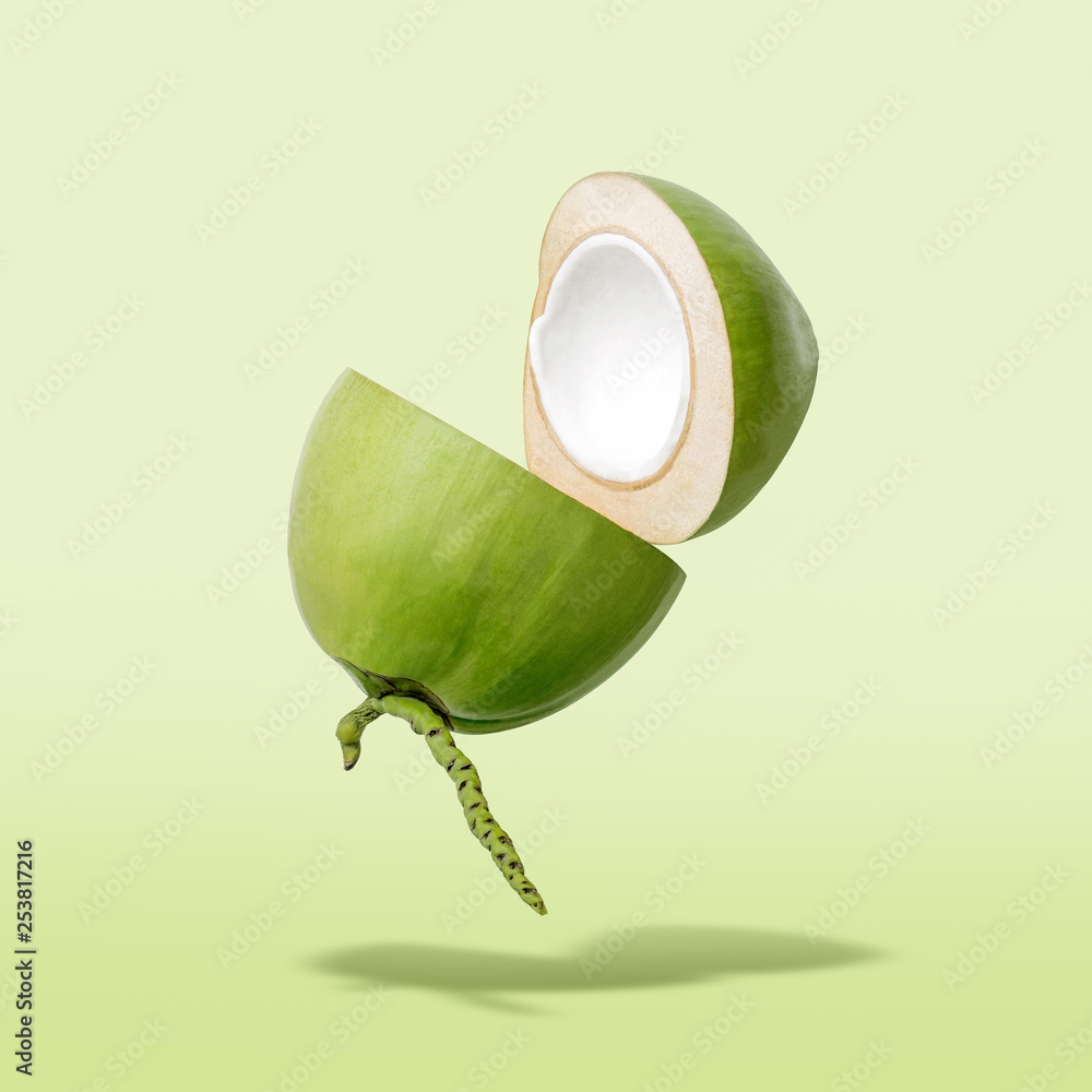Flying green coconut on a pastel green background, creative summer food ...
