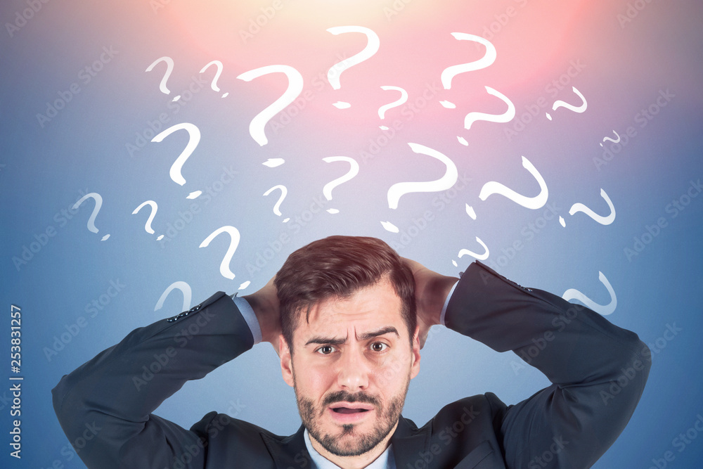 Confused businessman, question marks blue Stock Photo | Adobe Stock