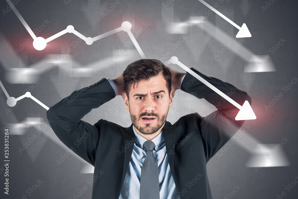 Confused businessman, falling graphs Stock Photo | Adobe Stock
