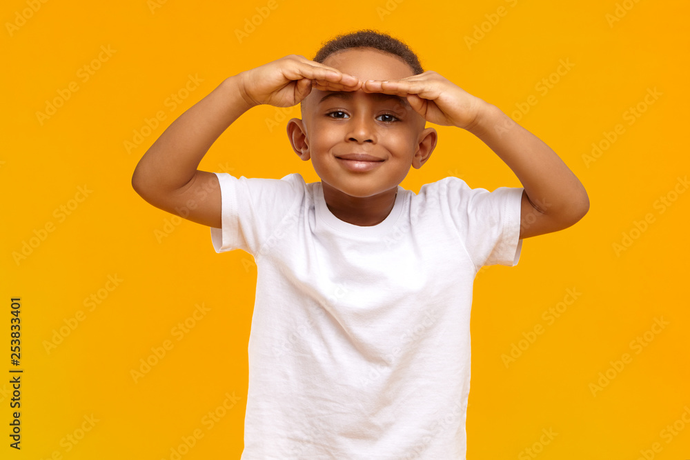 Isolated image of cute seven year old dark skinned male child in white ...