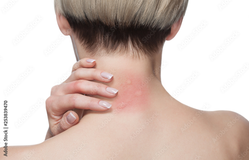 Girl with blond hair, sitting with his back turned and scratching ...