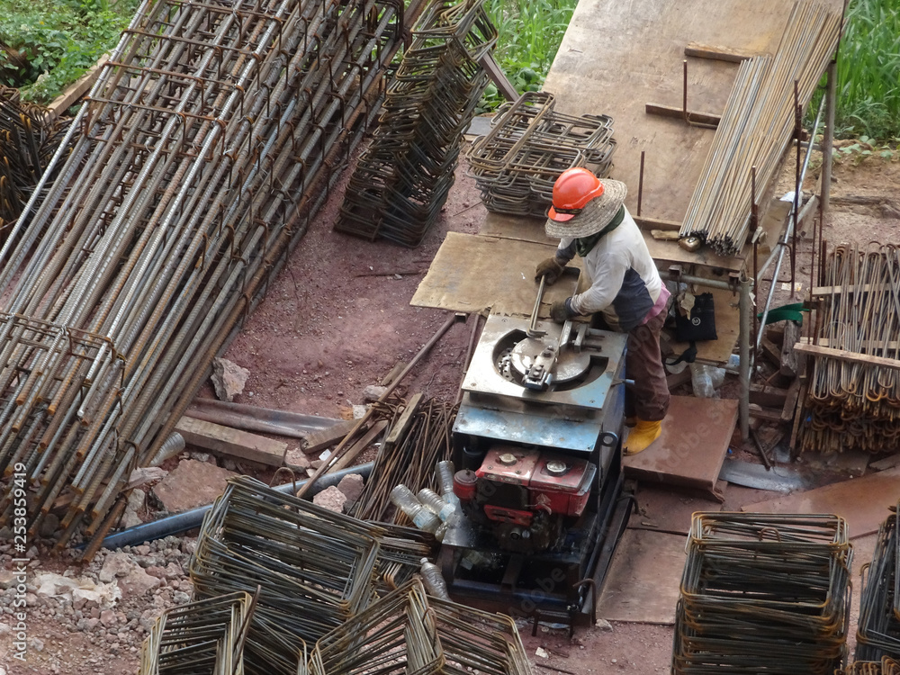 Construction workers working at the steel reinforcement bar bending ...