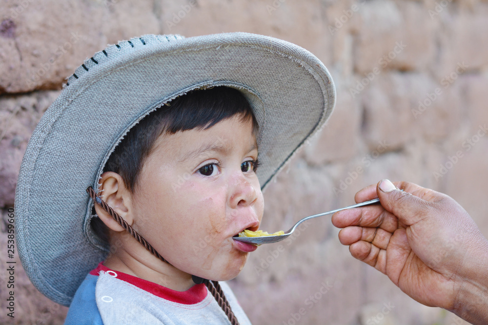 Foto de Native american woman feeding her little son in the countryside ...