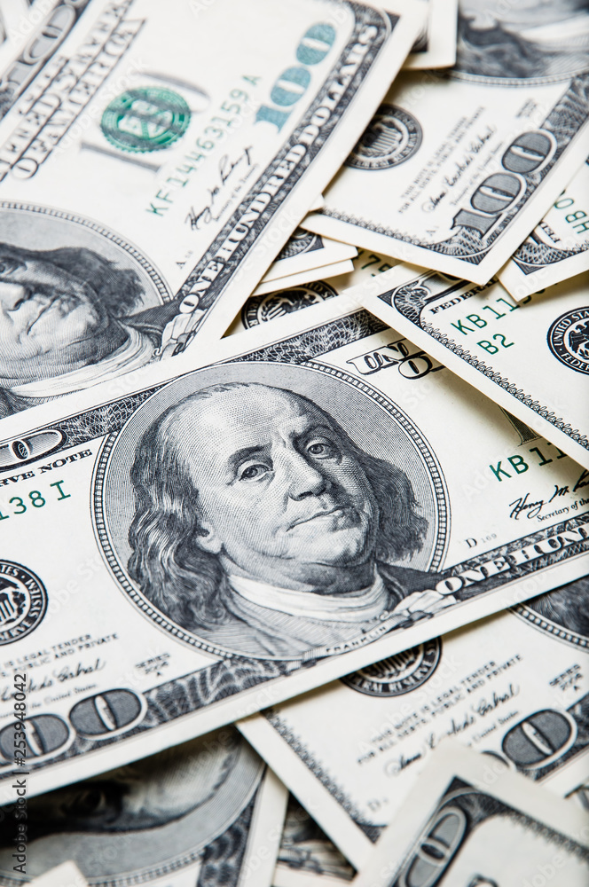 Background from dollars. Notes of one hundred American dollars are ...