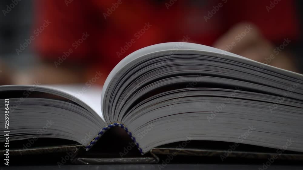 Reading old textbook in university library, read book or relaxing in ...