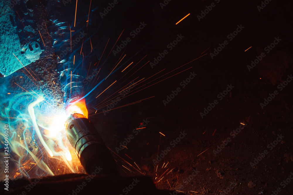 Arc welding. Welding of two metal plates in inert gases. MIG / MAG. A ...