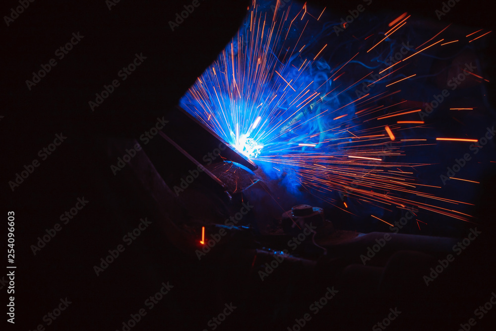 Arc welding. Welding of two metal plates in inert gases. MIG / MAG. A ...
