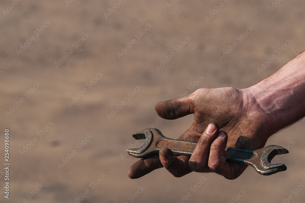 Dirty hands mechanics after the repair of equipment. Spanner wrench in ...