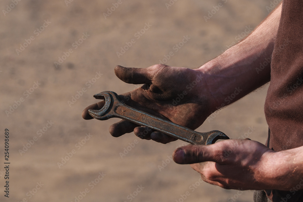 Dirty hands mechanics after the repair of equipment. Spanner wrench in ...