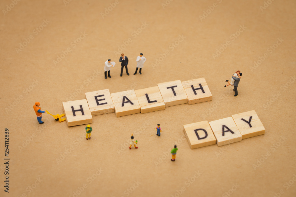 Miniature people standing with wood word Health Day using as background ...