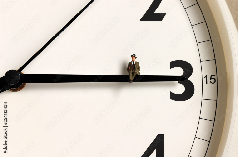 Poster A miniature man sitting on a clock needle. – Wall Art | UkPosters