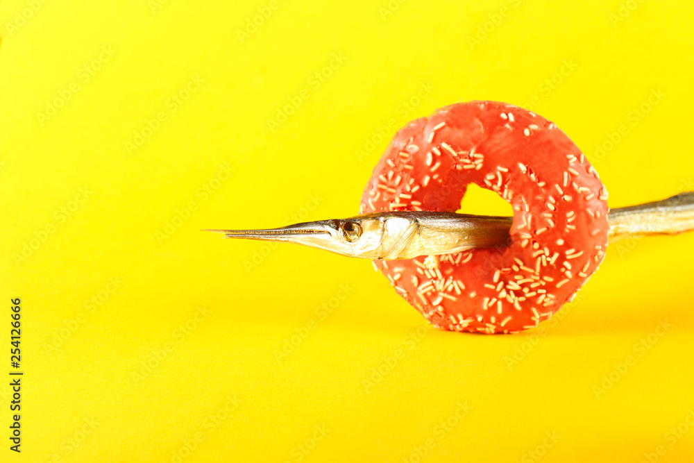 dry fish in a donut on a bright background Stock Photo | Adobe Stock
