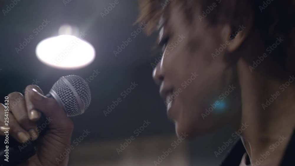Video Stock Close up of one young African female singer singing in the ...