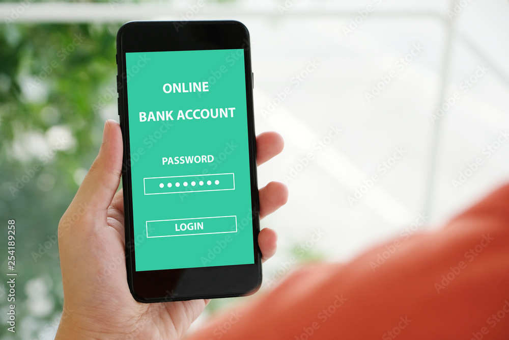 Hand using smartphone with online bank account password login on screen ...