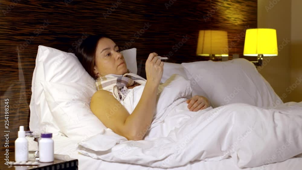 Vídeo do Stock: woman with a fever is lying in bed at home. great body ...