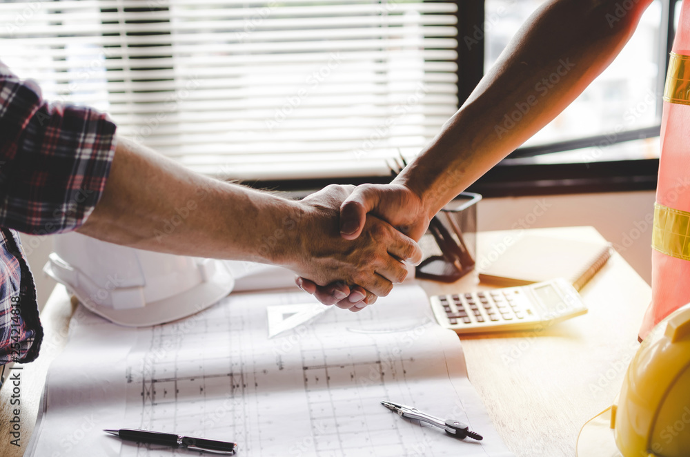 view of construction worker team contractor hand shake after finishing ...