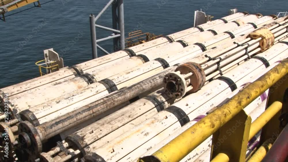 Zooming out of a storage of oil drill pipes on an offshore oil and gas ...