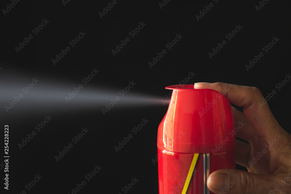 Hand holding mosquito spray. Human using mosquito spray from bottle ...
