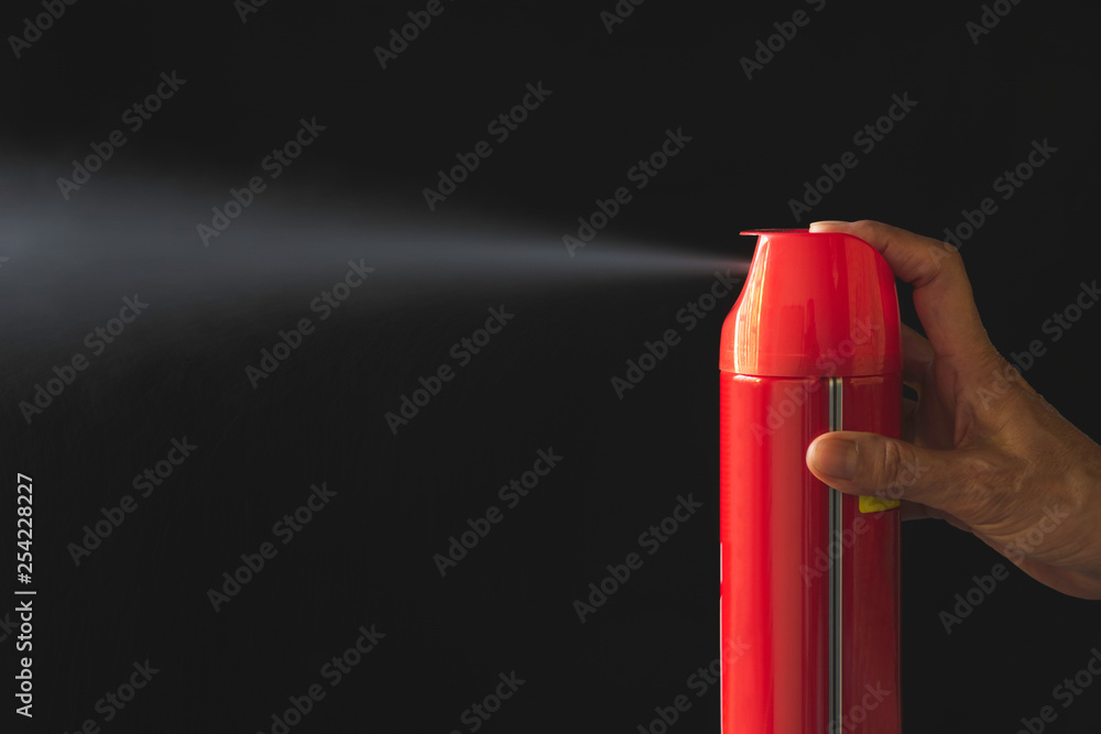 Hand holding mosquito spray. Human using mosquito spray from bottle ...