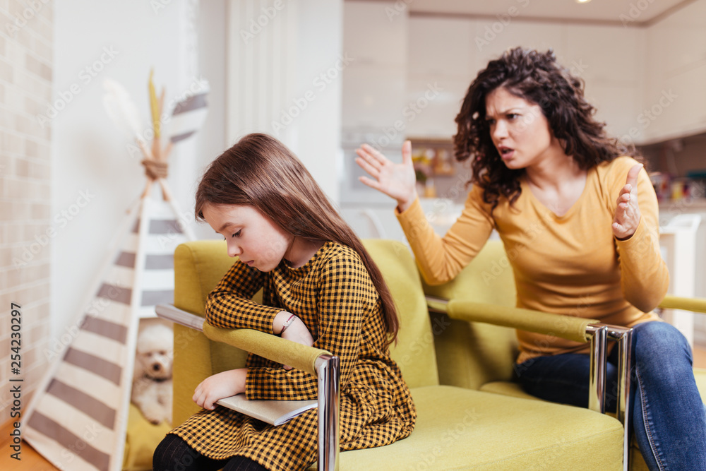 Young mother arguing with her little daughter. Stock Photo | Adobe Stock