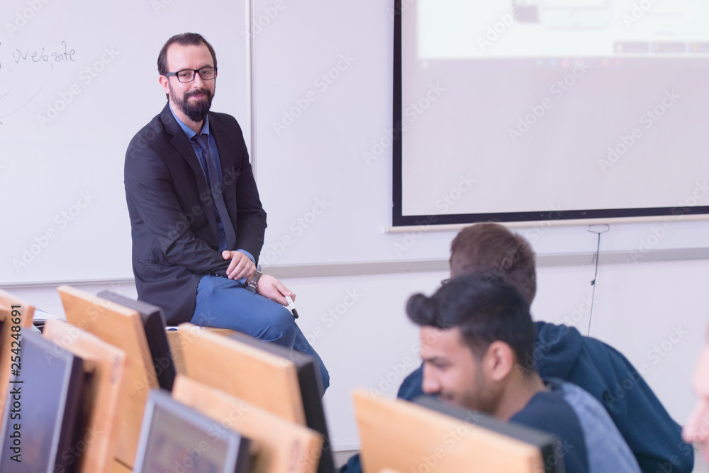 Group of students study with professor in modern school classroom. Male ...