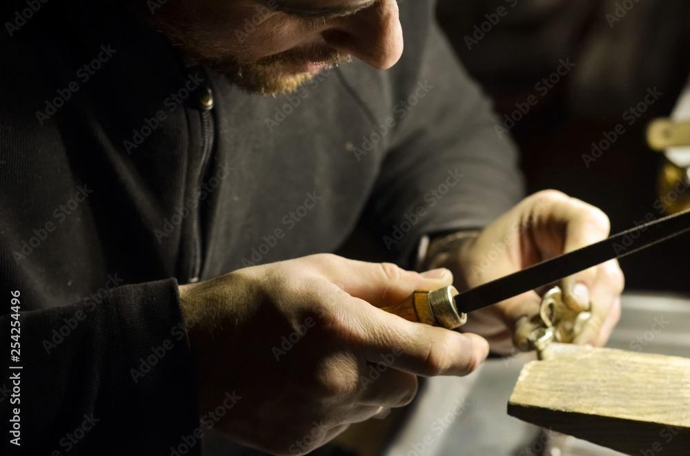The master jeweler holds the working tool in his hands and makes ...
