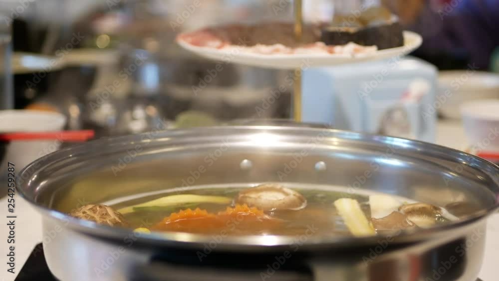 Cooking hotpot (Shabu-shabu) with a bunch of vegetables and meat in the ...