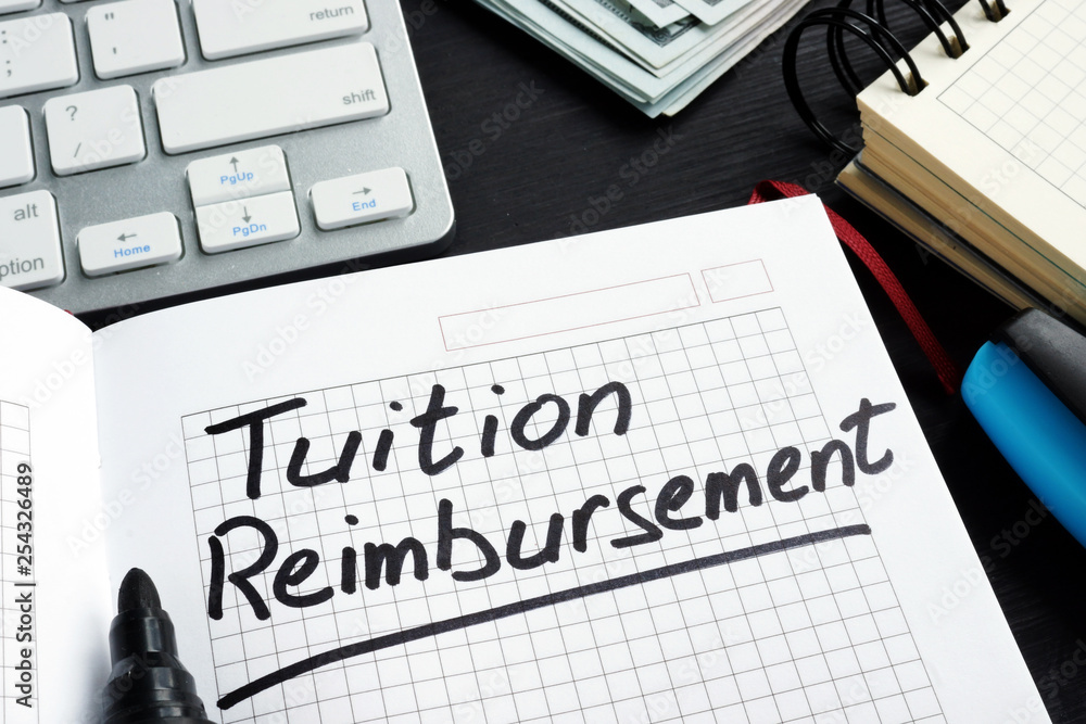 Tuition reimbursement written on a page of notepad. Stock Photo | Adobe ...