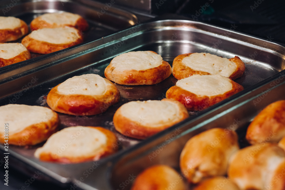 Delicious fresh baked flavored buns set made of sweet dough laying on ...