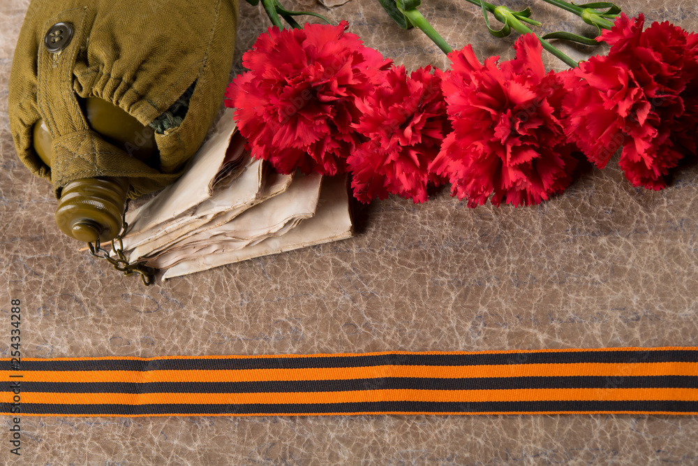 St. George ribbon on the background of old paper, with a set of items a ...