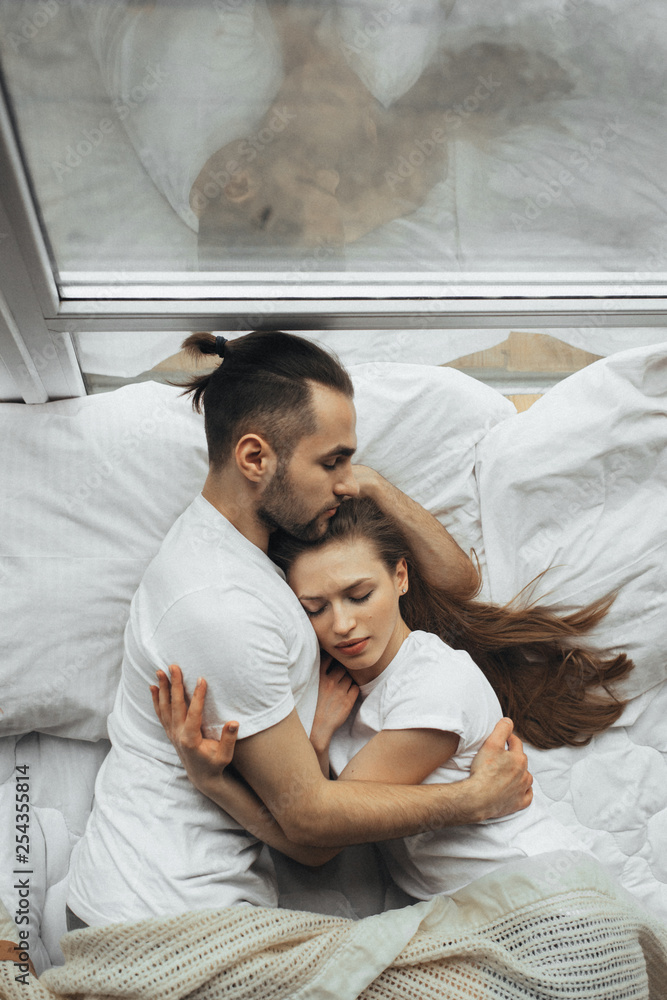 Beautiful loving couple kissing in bed Stock Photo | Adobe Stock