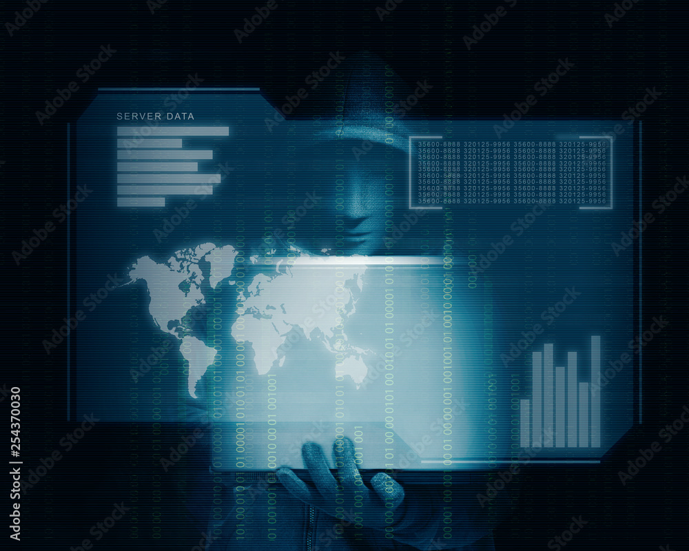 Hacker in black hoodie holding laptop with his hand and virtual screen ...