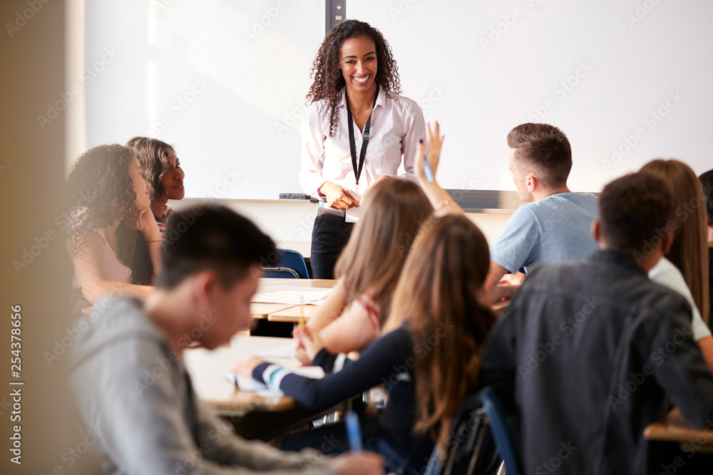 Female High School Teacher Standing In Front Of Interactive Whiteboard ...