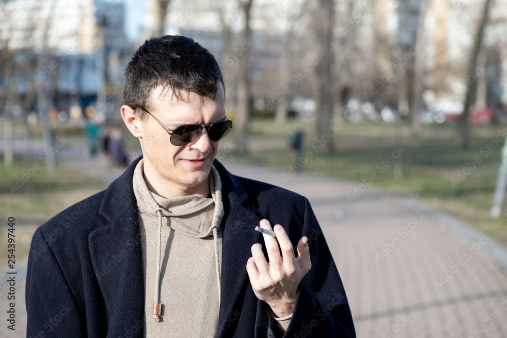 Stop smoking, Young smoker man with sunglasses holding smoking ...