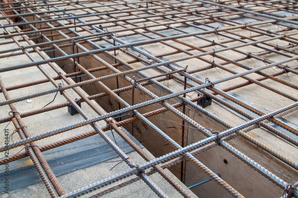 close up view of reinforcement of concrete with metal rods connected by ...