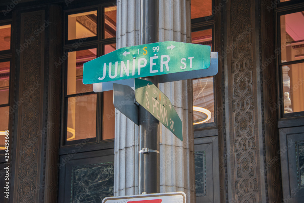 Juniper Street and South Penn Square street signs on pole in center ...