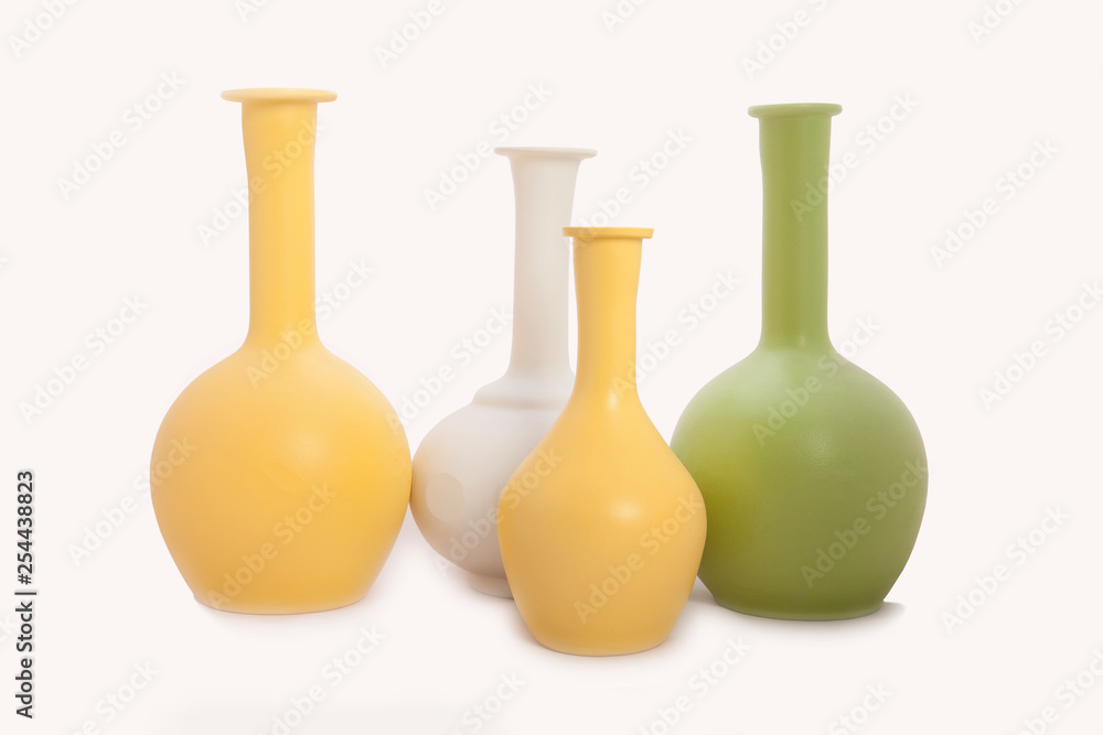Four multi-colored vases on a white background. The uniform color of ...