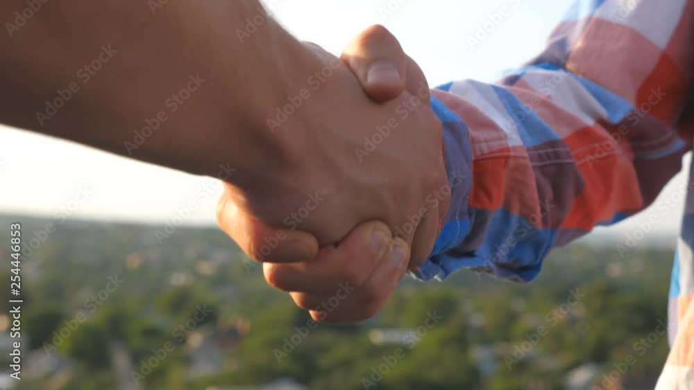 Two friends meeting on rooftop and greeting each other. Young men ...