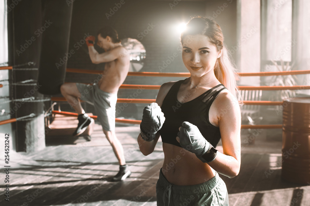 Female boxer doing shadow boxing inside a boxing ring. Boxer practicing ...
