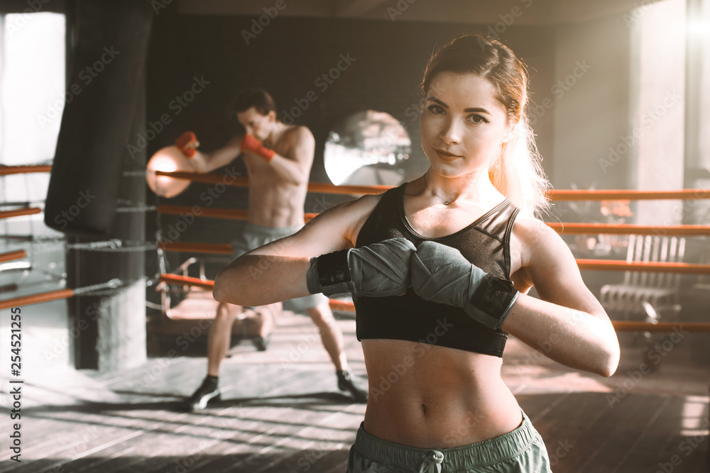 Female boxer doing shadow boxing inside a boxing ring. Boxer practicing ...