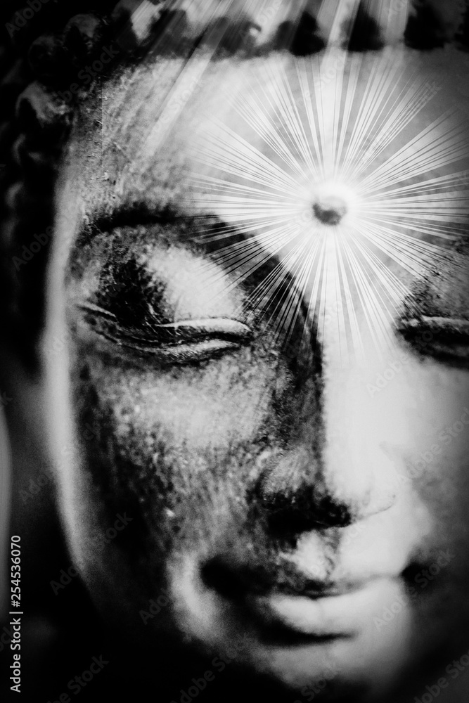 Soft spiritual sun rays on a buddha face close up shot. Buddhist ...