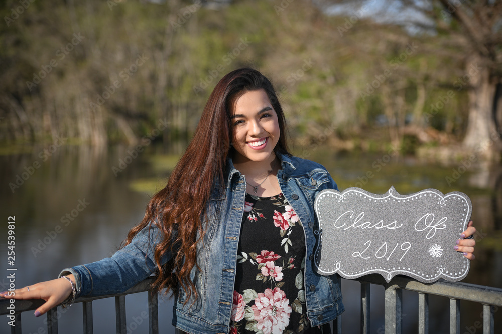 Beautiful high school senior at the park. Posing for graduation ...