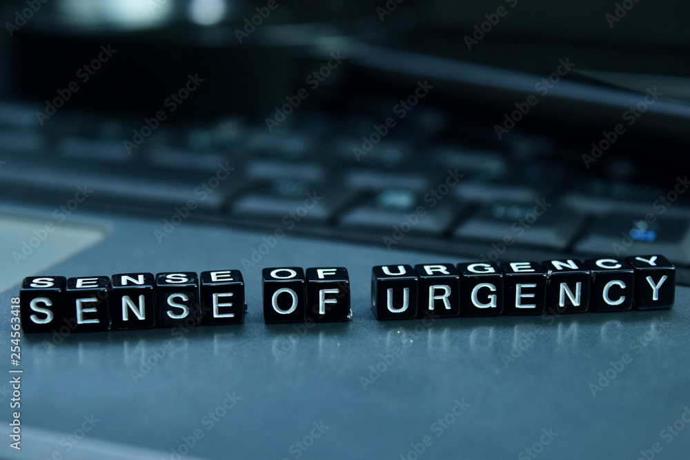Sense of urgency text wooden blocks in laptop background. Business and ...