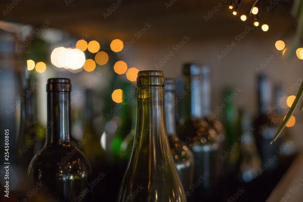 decorative interior elements-dark glass empty bottles .Many glass wine ...