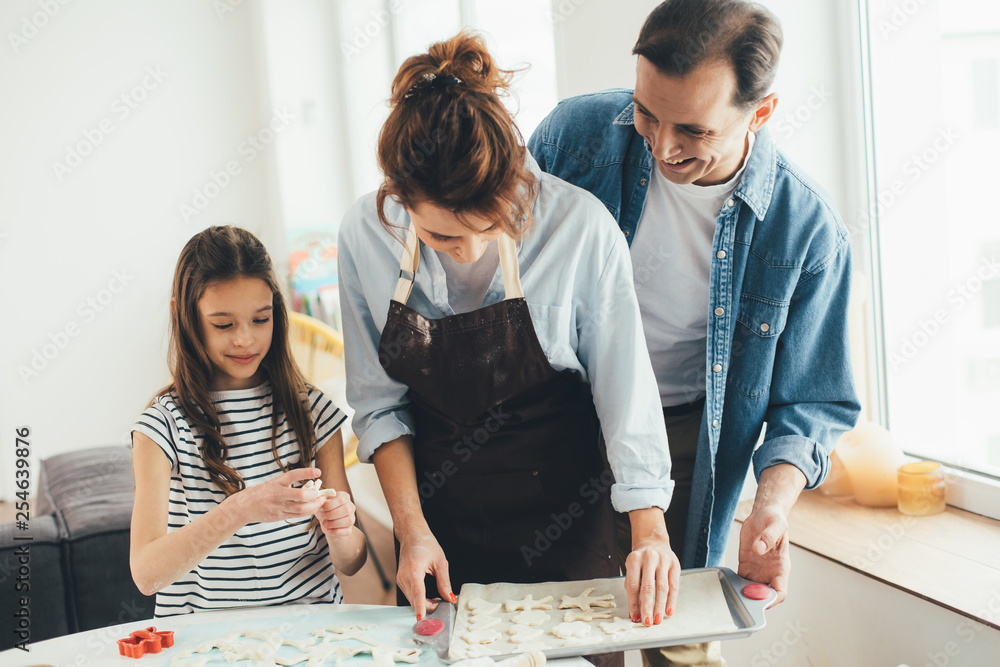 Happy family making cookies together on kitchen Stock Photo | Adobe Stock