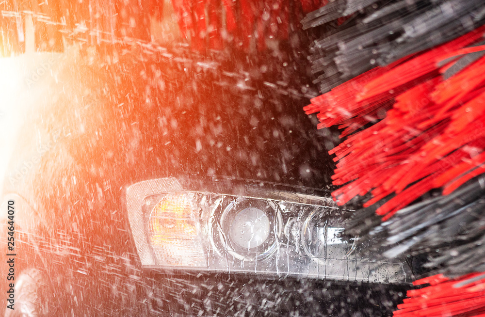 Automatic car wash in action. Car wash concept. Automated technology ...