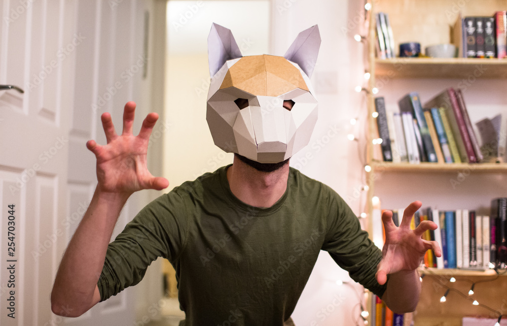 A man poses like an animal while wearing a fox mask carefully made from ...
